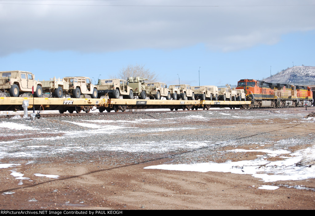BNSF 4779 passes me by as the HUM V's on flatcars go by.